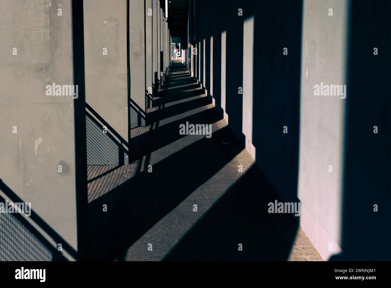 Game of shadows and highlights at a arched walkway. Pedestrian path ...