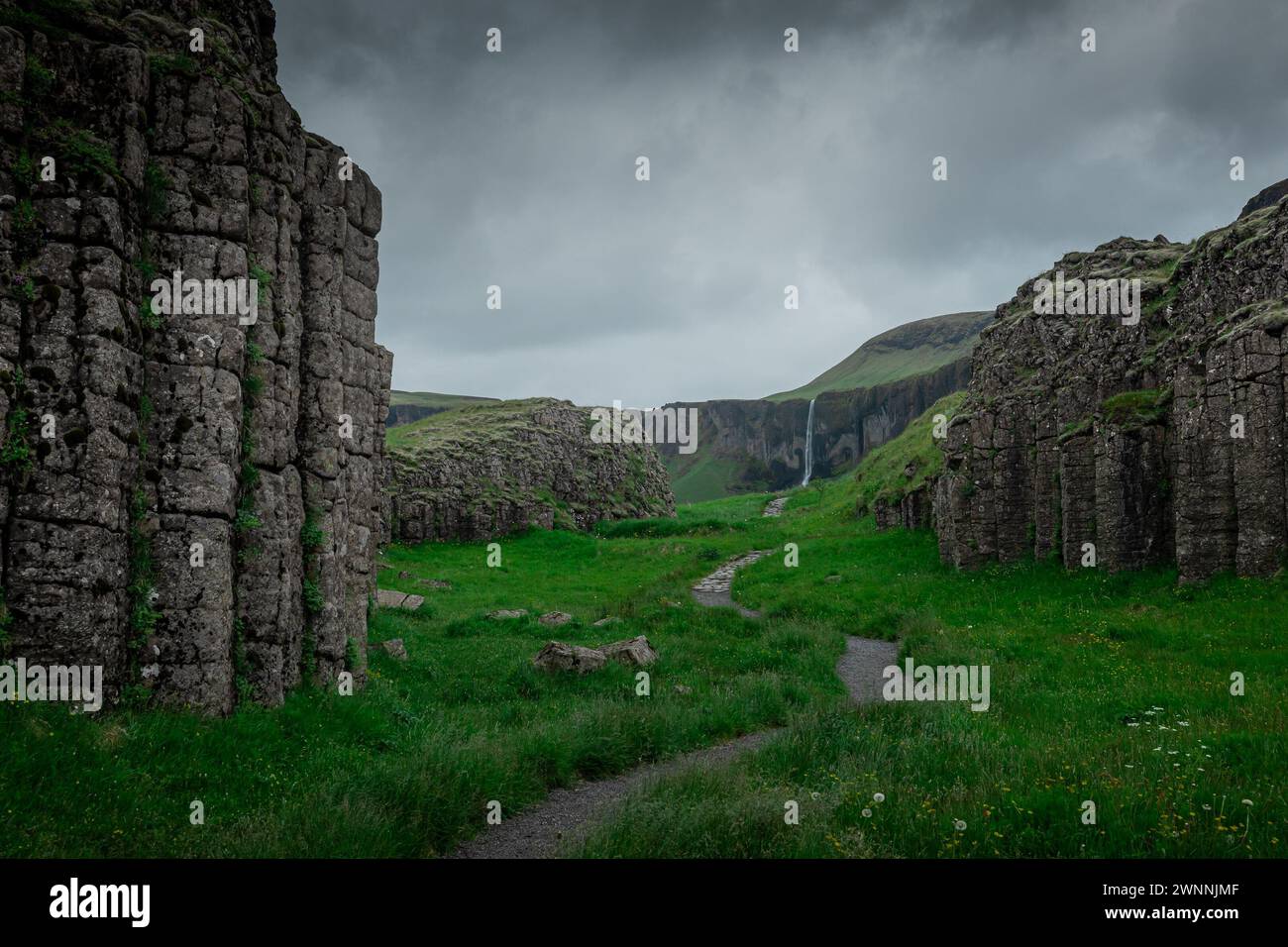 Basalt pillars rising from the ground in iceland, looking towards foss ...