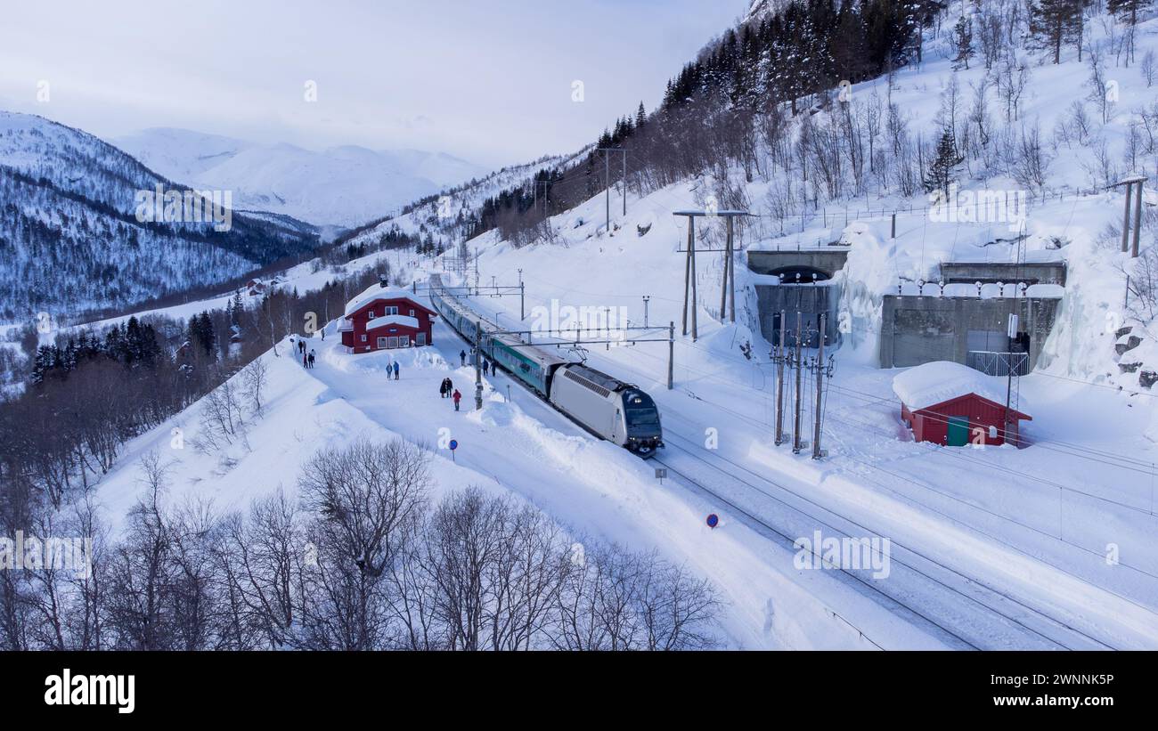 Aerial drone view of a norwegian passenger train standing on a platform ...