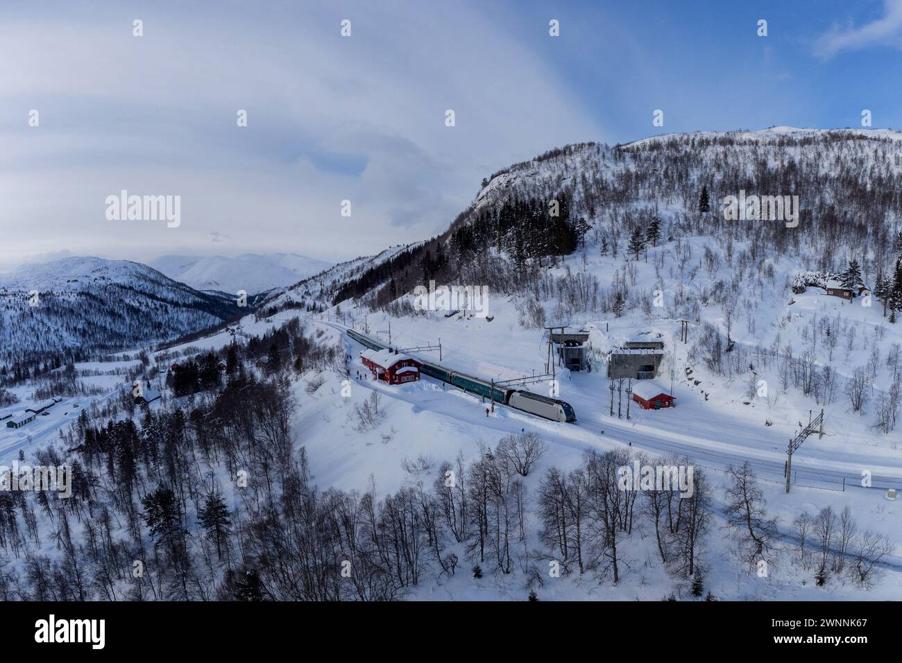 Aerial drone view of a norwegian passenger train standing on a platform ...