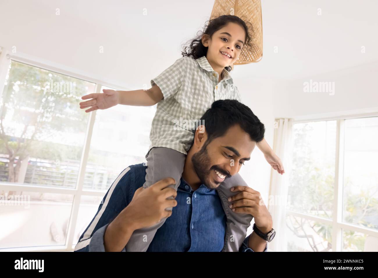 Happy loving young Indian dad carrying daughter kid on shoulders Stock ...