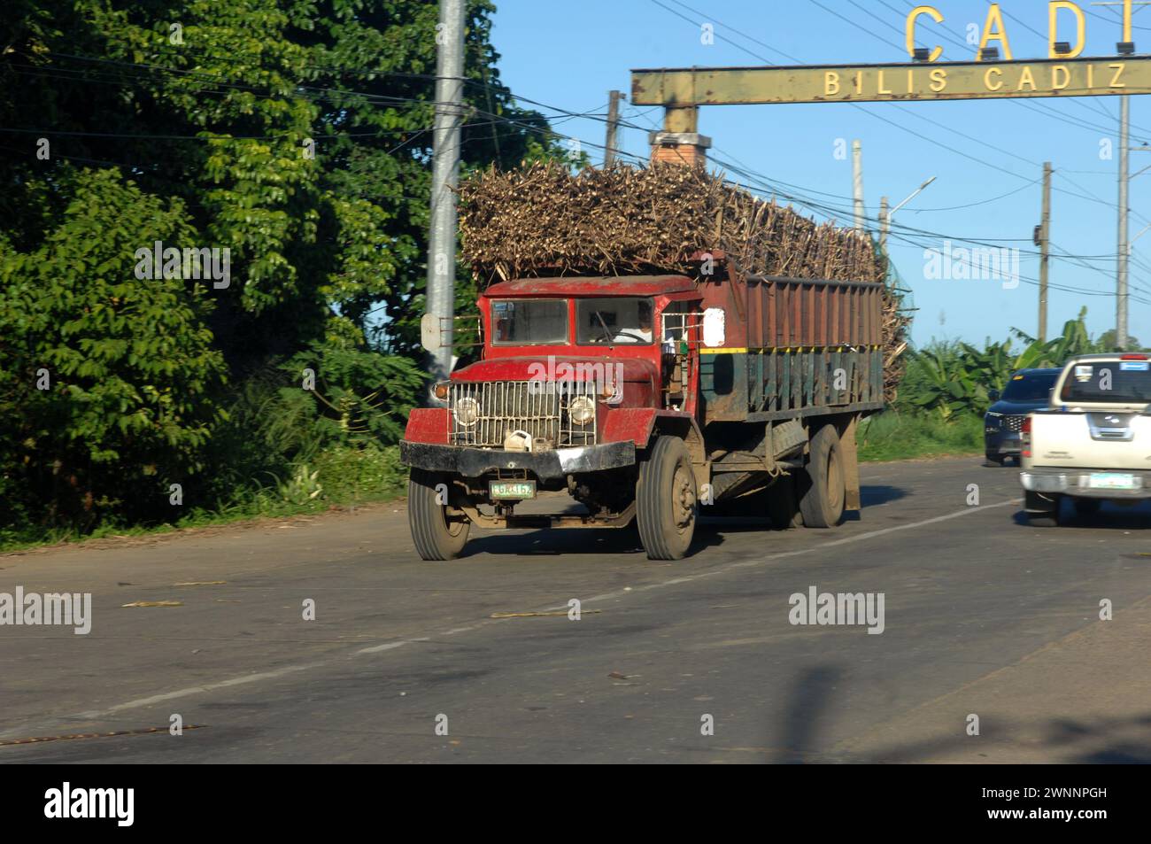 Overloaded trucks carrying sugarcane crop on road from Cadiz City to ...