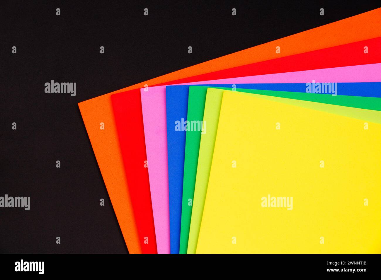 Black background with sheets of rainbow colored foam Stock Photo - Alamy