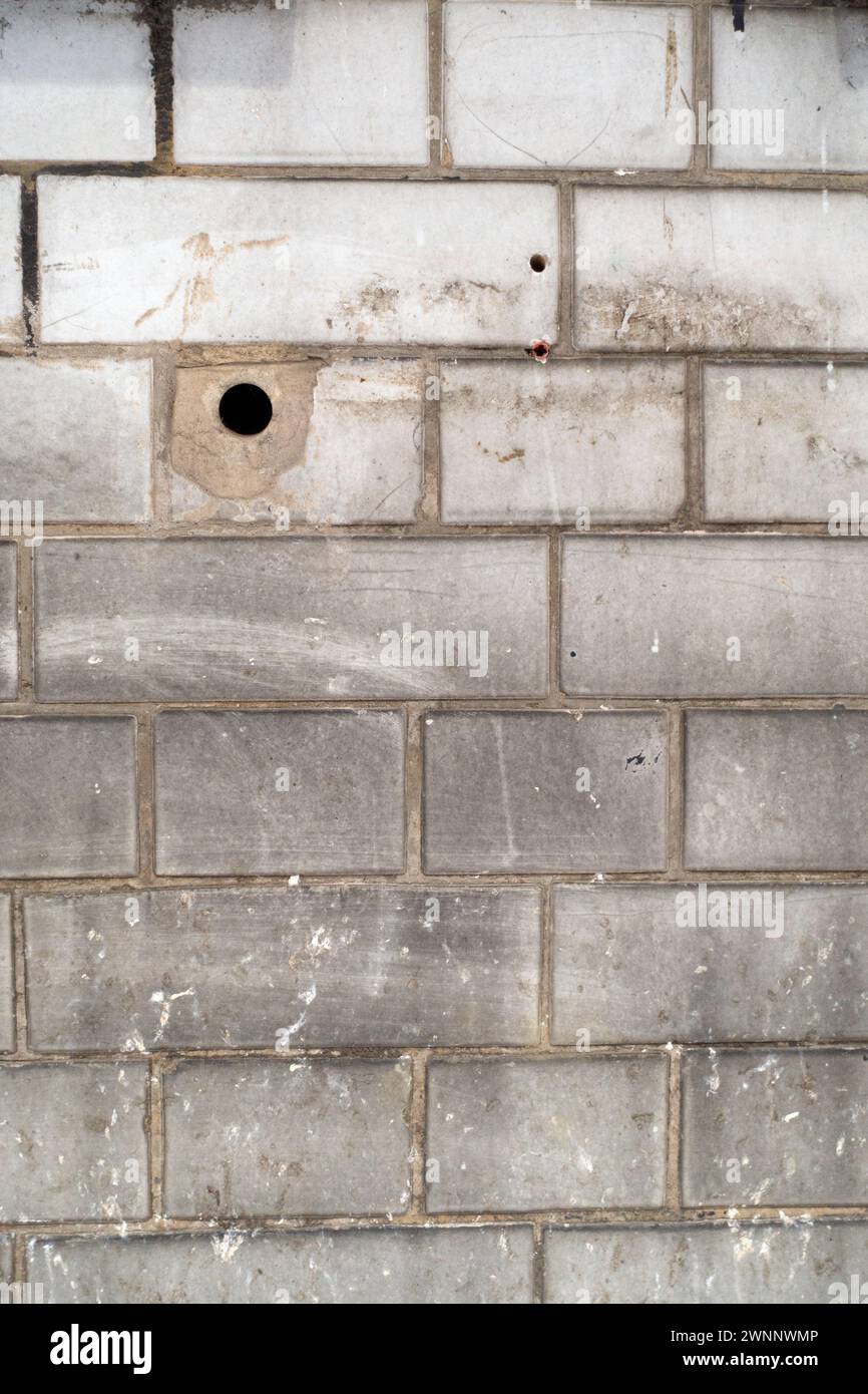 A White Industrial Wall with Bricks and Stains and Dark Grouting Stock ...