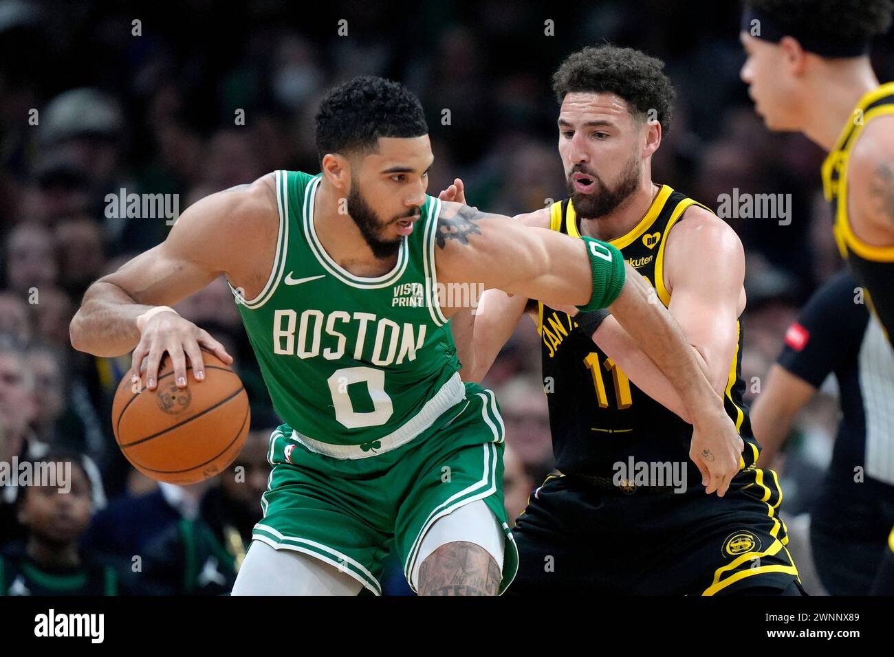 Boston Celtics forward Jayson Tatum (0) drives to the basket as Golden ...