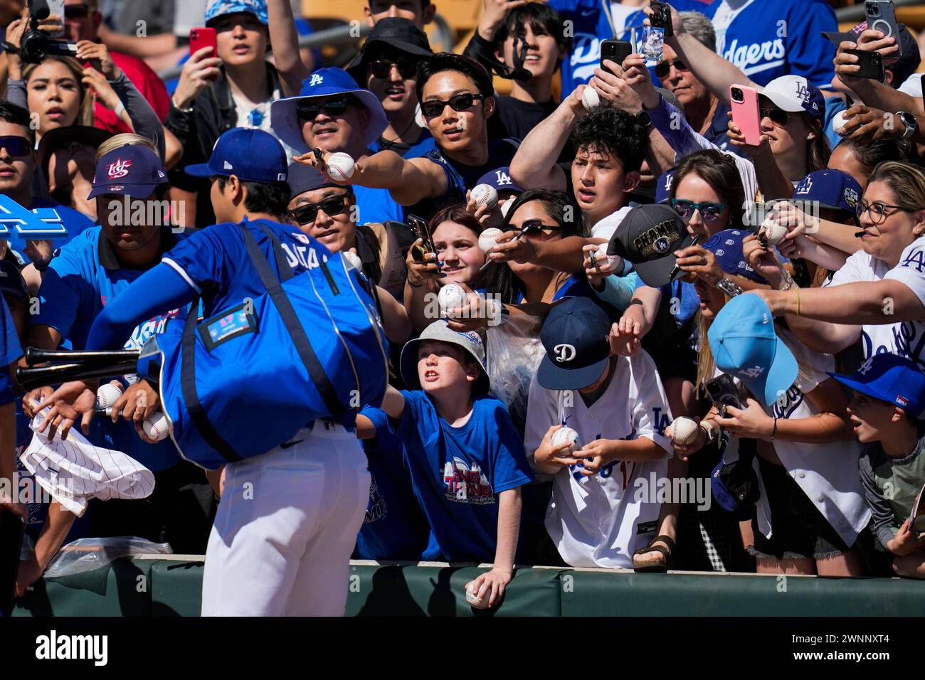 Los Angeles Dodgers designated hitter Shohei Ohtani signs autographs ...