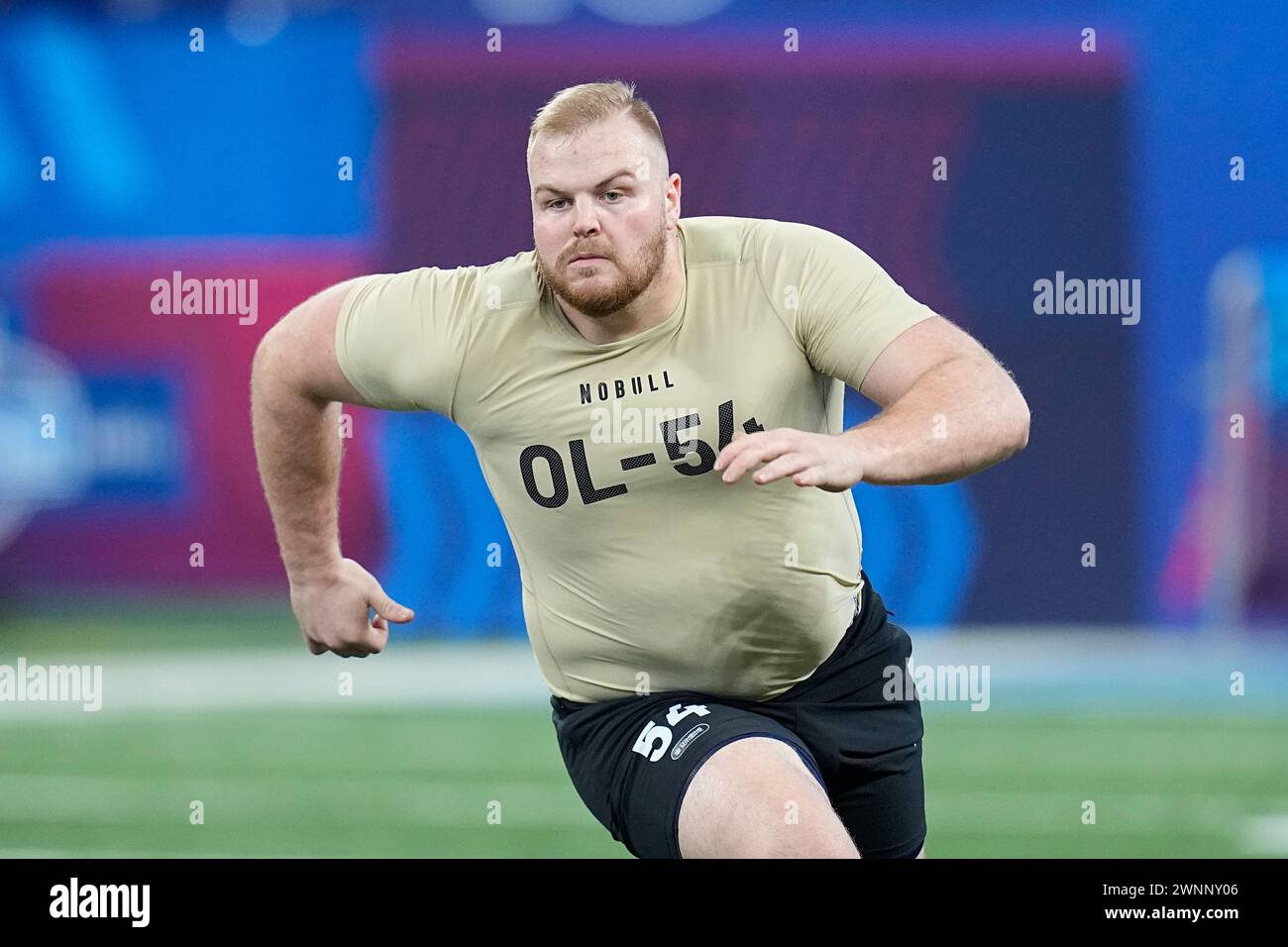 Michigan offensive lineman Drake Nugent runs a drill at the NFL ...