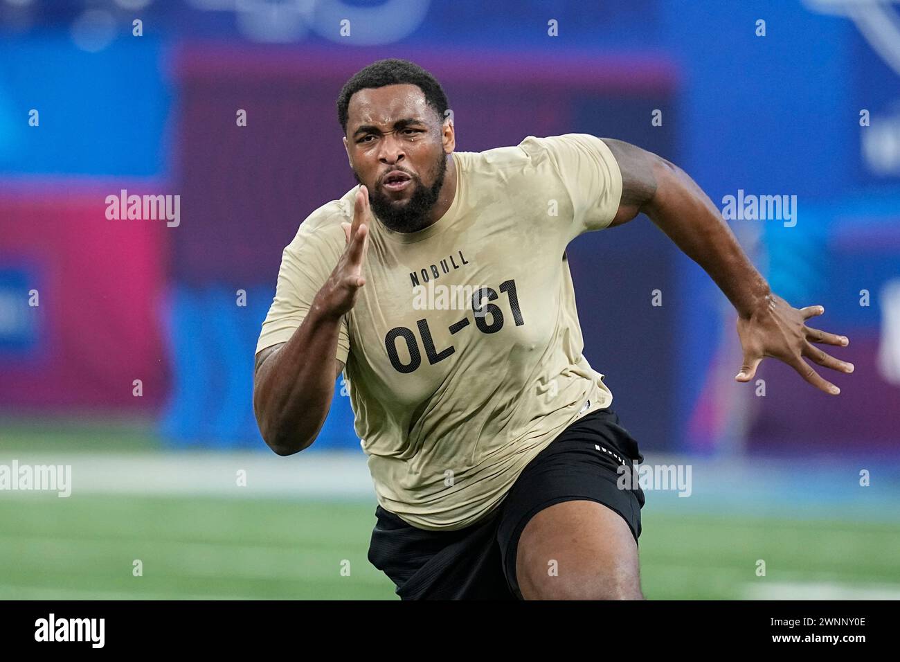 Texas A&M offensive lineman Layden Robinson runs a drill at the NFL football scouting combine ...