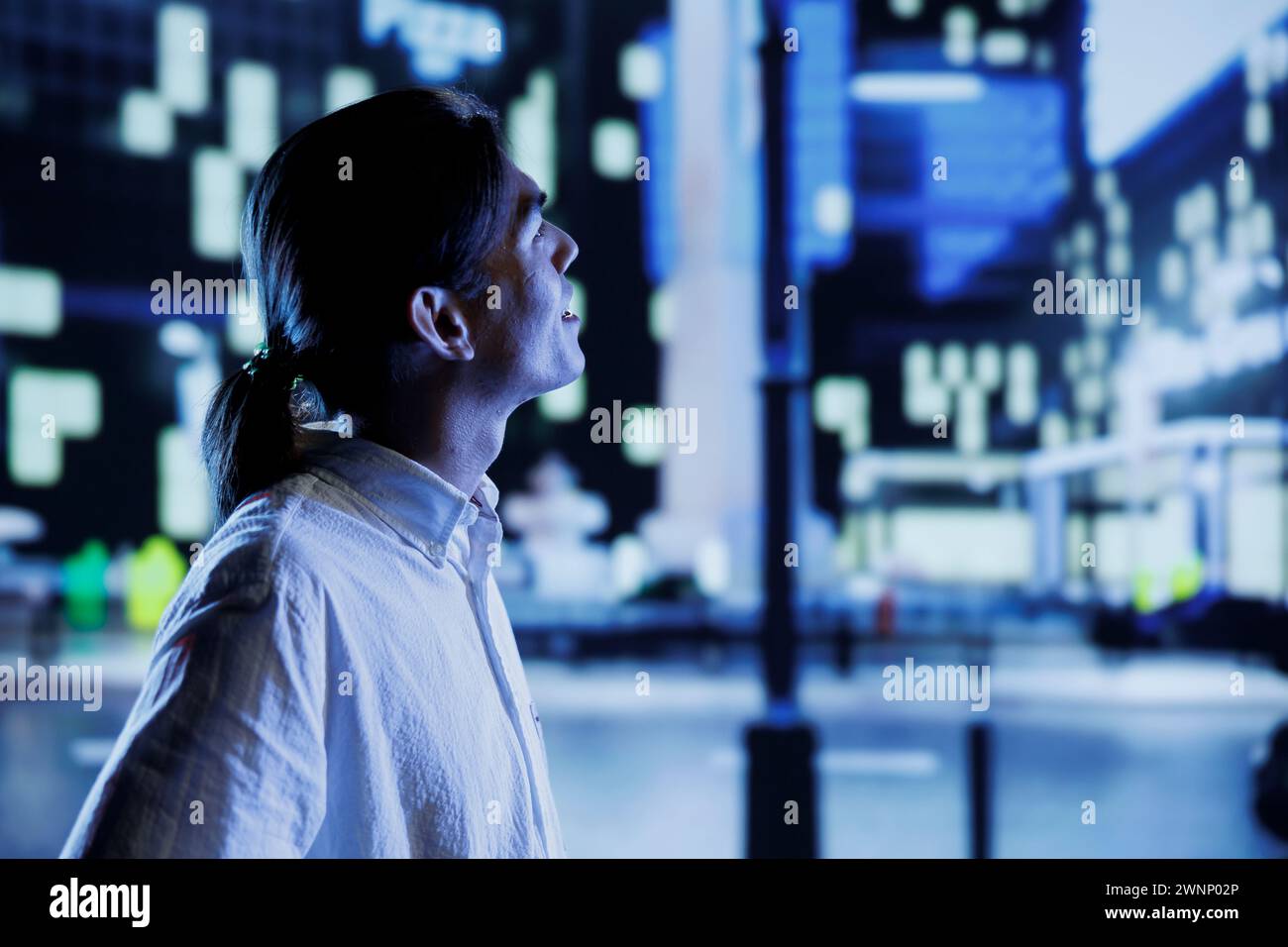 BIPOC man wandering around city streets during nighttime, being amazed ...