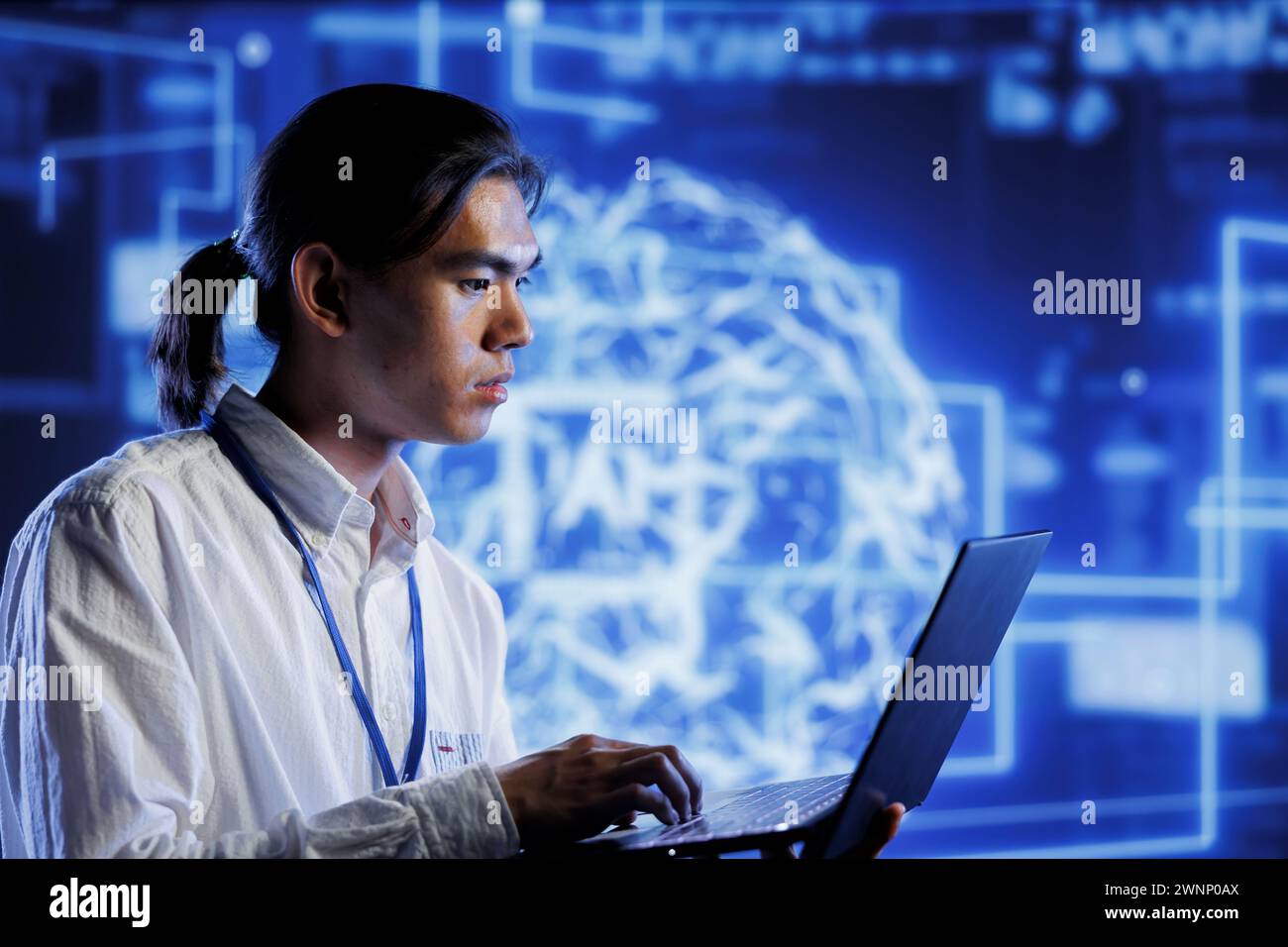 Qualified technician using laptop to maintenance artificial intelligence neural networks ...