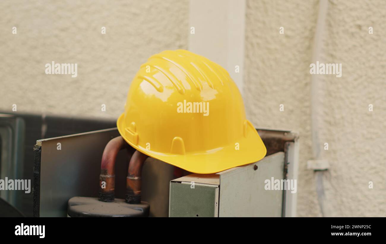 Extreme close up of yellow safety hardhat on top of out of order ...