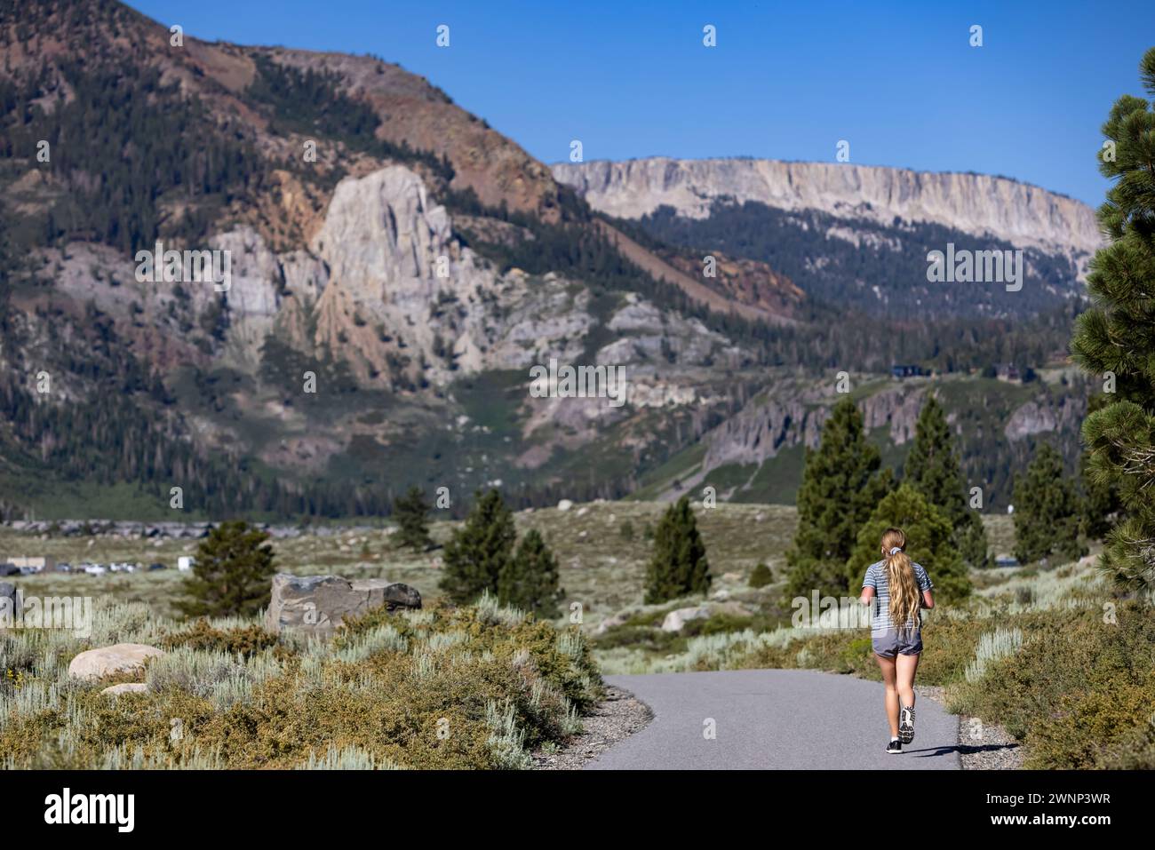A jogger on the Mammoth Lakes Town Loop path with a view of Mammoth ...
