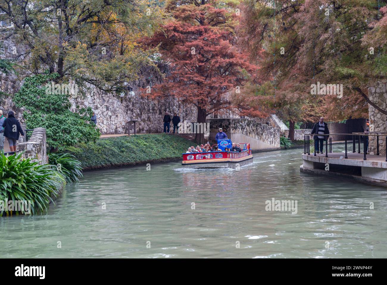 Tourists ride the Rio San Antonio Cruise boat through the River Walk in ...