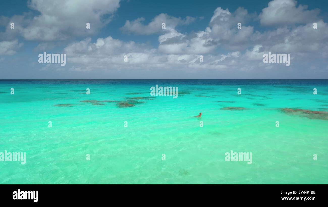 Girl enjoys tranquility tropical ocean, turquoise water sparkling ...