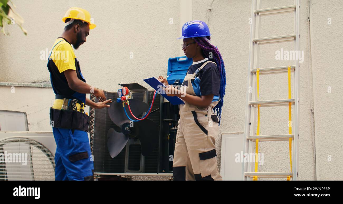 Diverse team of capable electricians brainstorming possible ways to ...