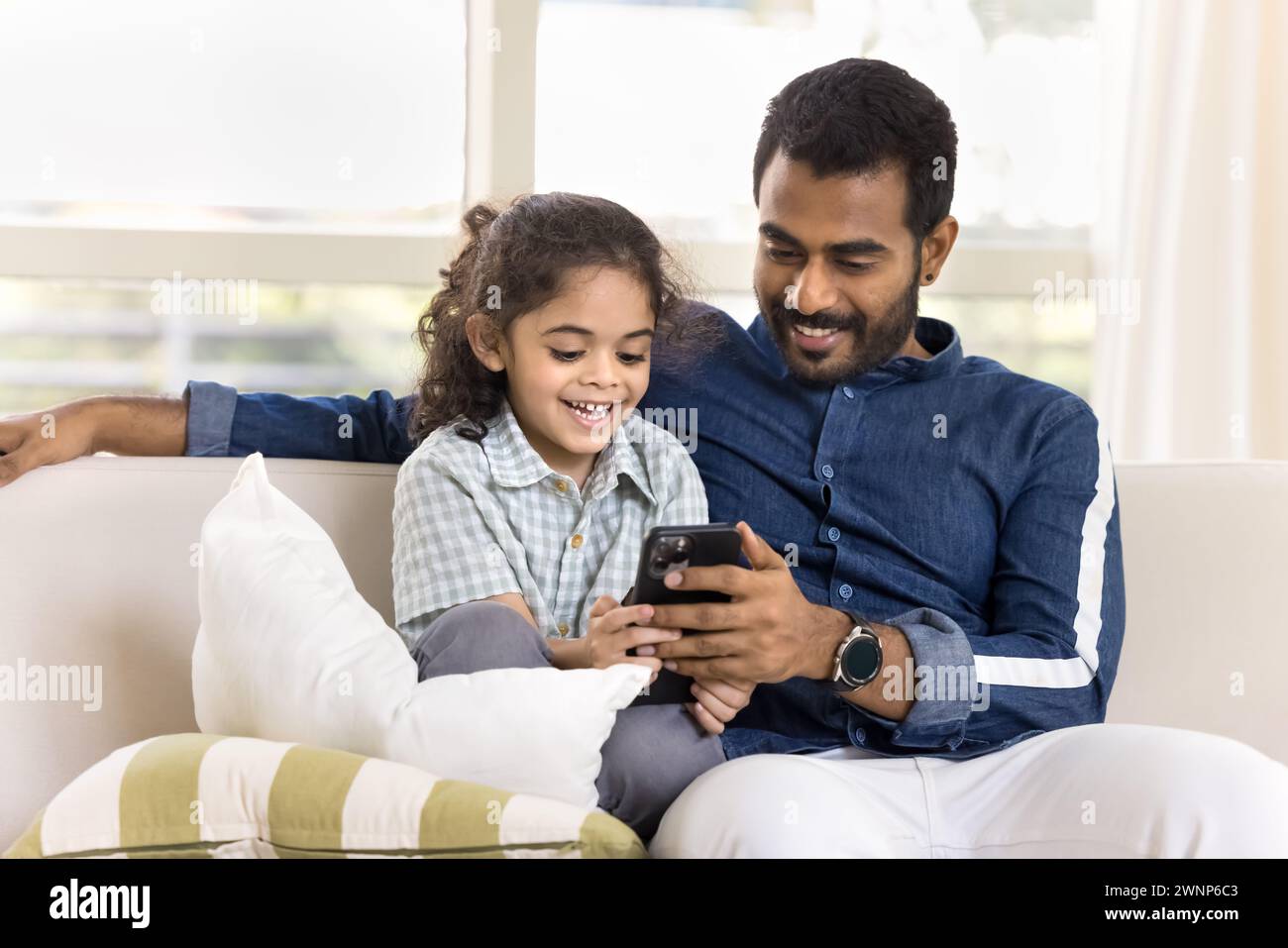 Happy Indian daughter and handsome dad watching funny online content Stock Photo - Alamy