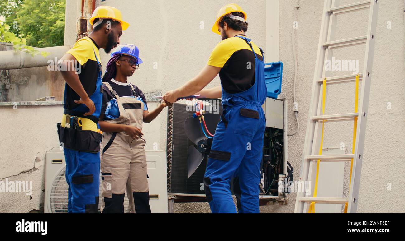 Diverse team experienced mechanics brainstorming hi-res stock ...