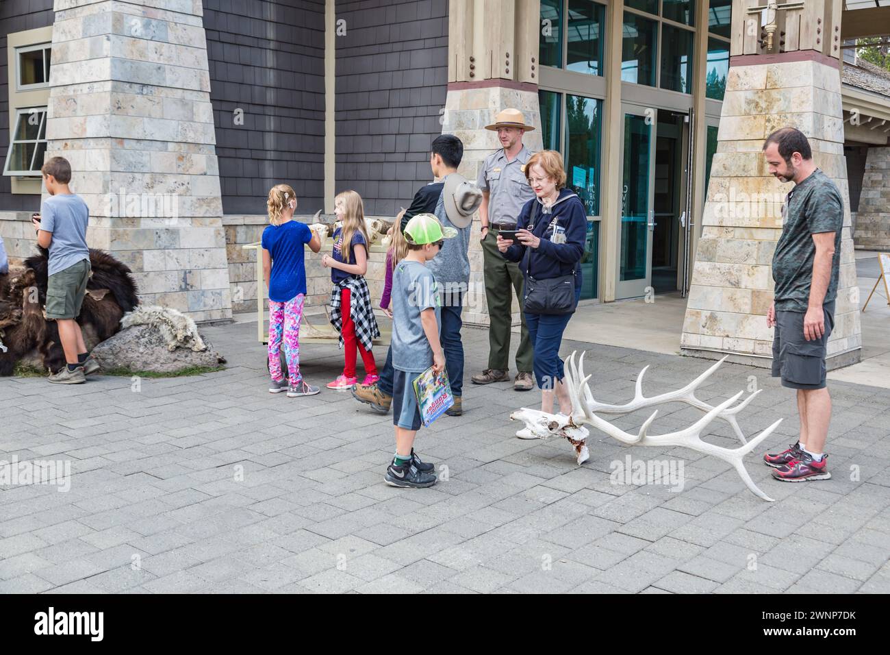 Park ranger supervises young park visitors with hands-on exhibits of ...