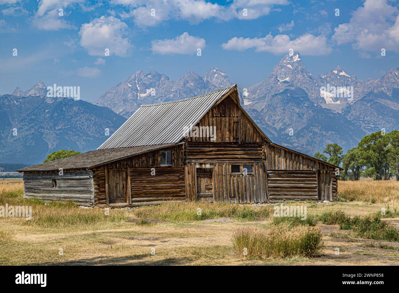 Peaks of the Grand Tetons rise up behind the T. A. Moulton Barn on ...