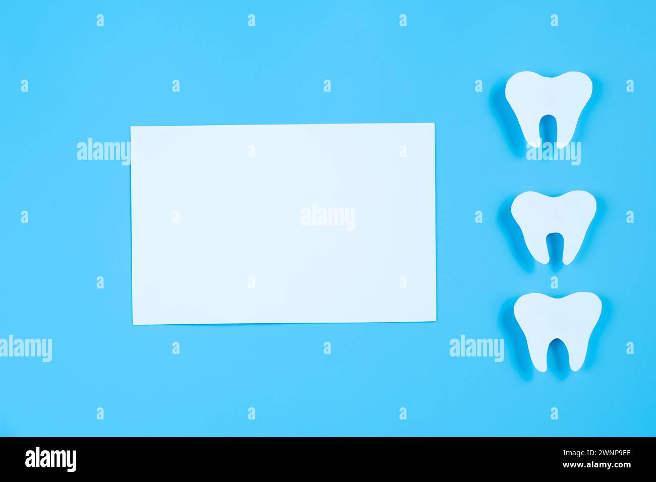 Paper cut mockup of tooth on blue background. Dental care concept. International Dentist Day ...