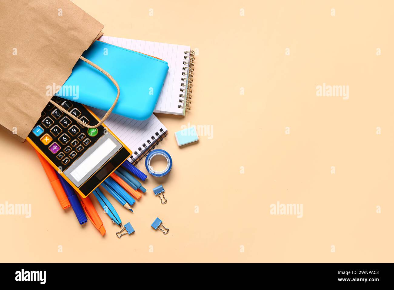 Shopping bag with different school stationery on beige background Stock ...
