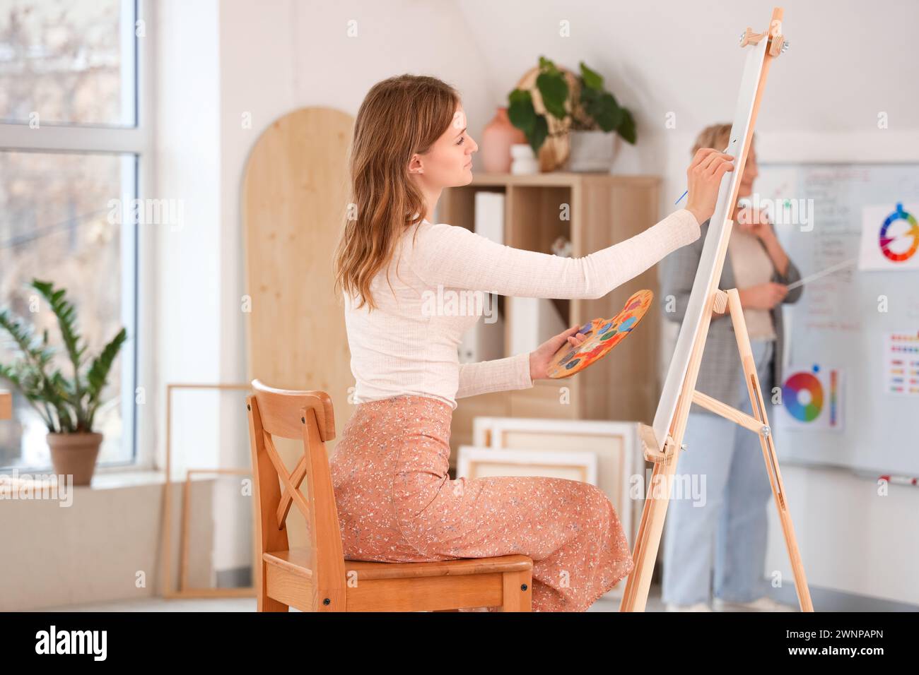 Female student drawing on canvas in art school Stock Photo - Alamy