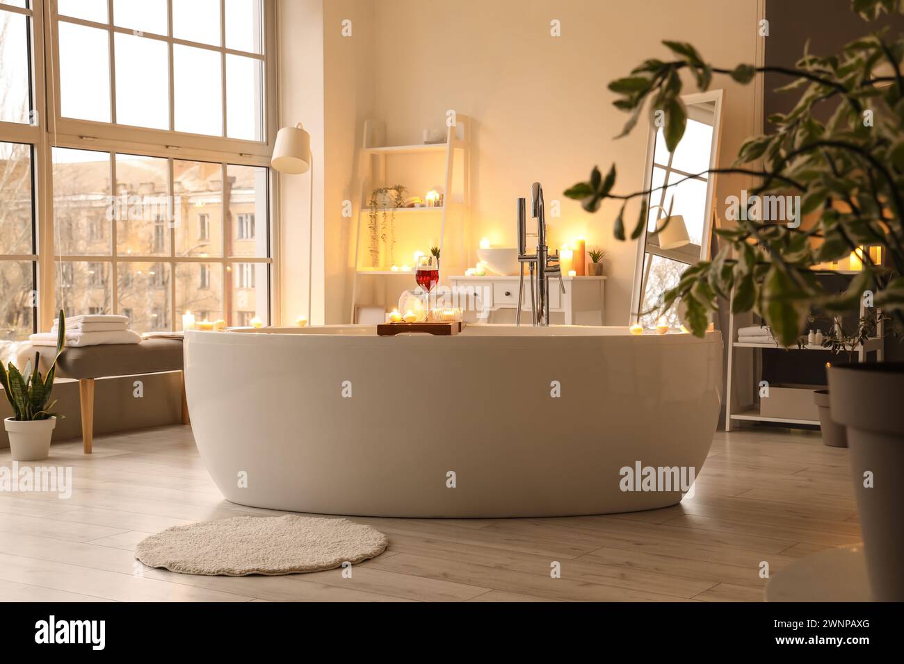 Interior of bathroom with bathtub and burning candles in evening Stock ...
