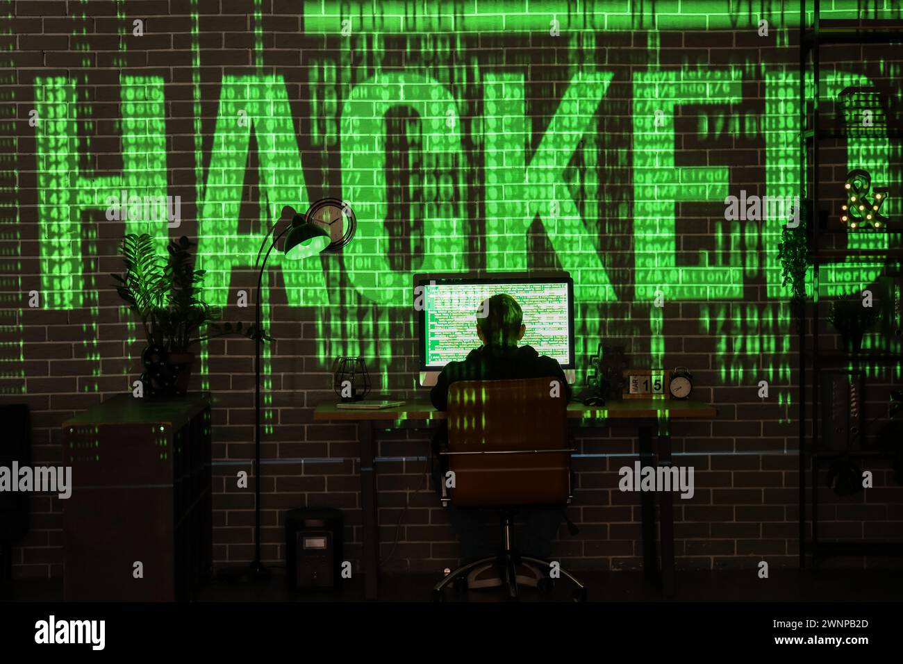 Hacker using computer at table and projection of word HACKED in dark room Stock Photo - Alamy