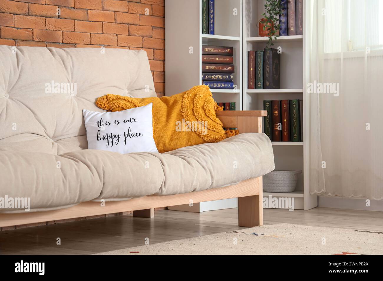 Interior of living room with couch and bookshelf Stock Photo - Alamy