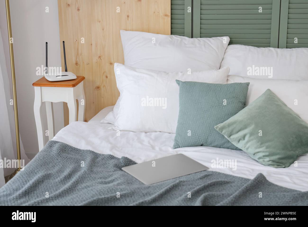 Modern wi-fi router on bedside table in room Stock Photo - Alamy