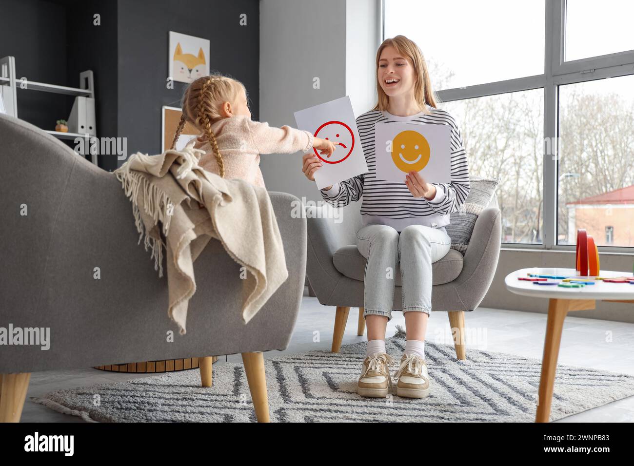 Little girl pointing at happy smile in psychologist's office Stock ...