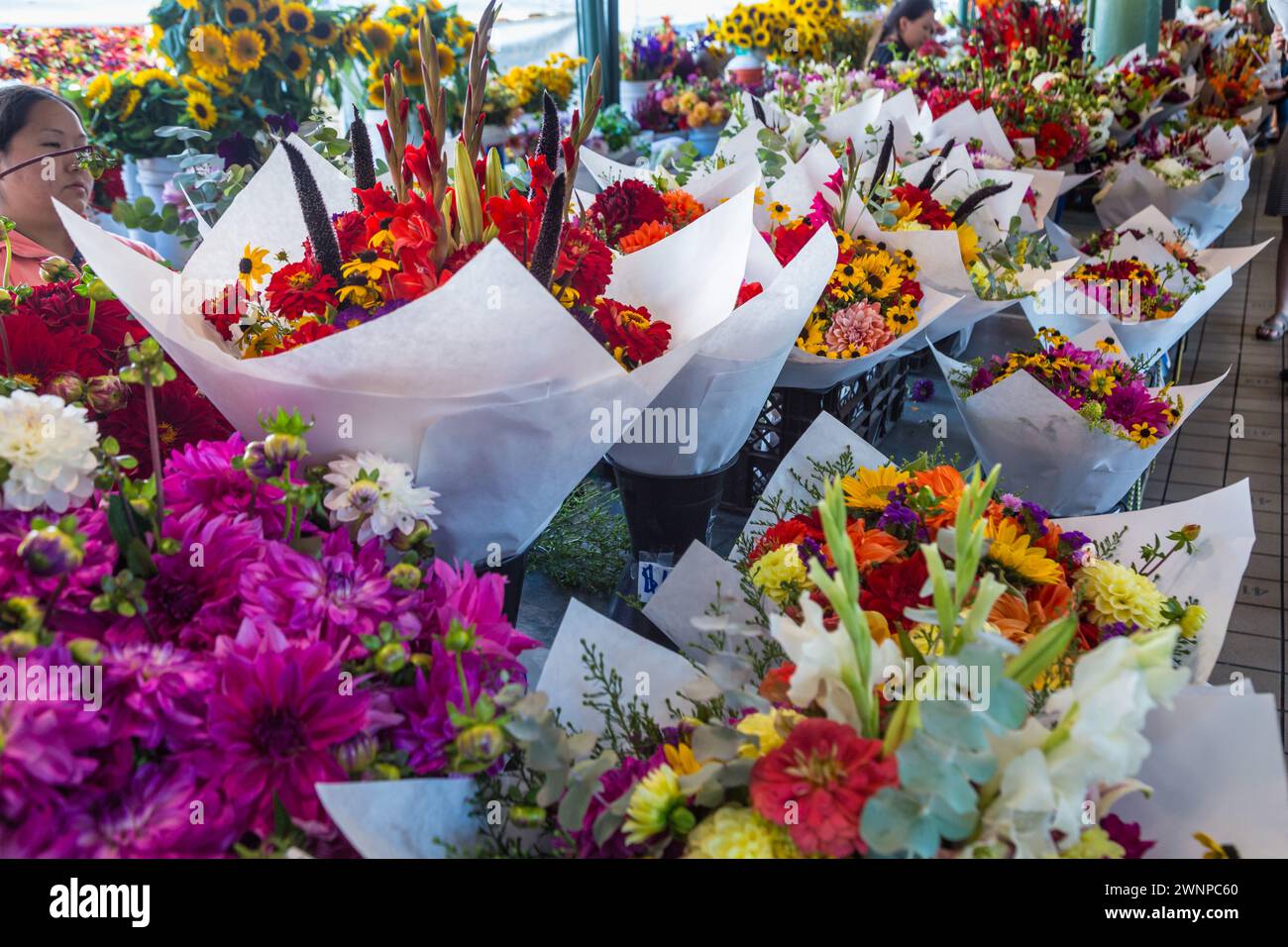 Women preparing flower arrangements for sale at the Pike Place Market ...