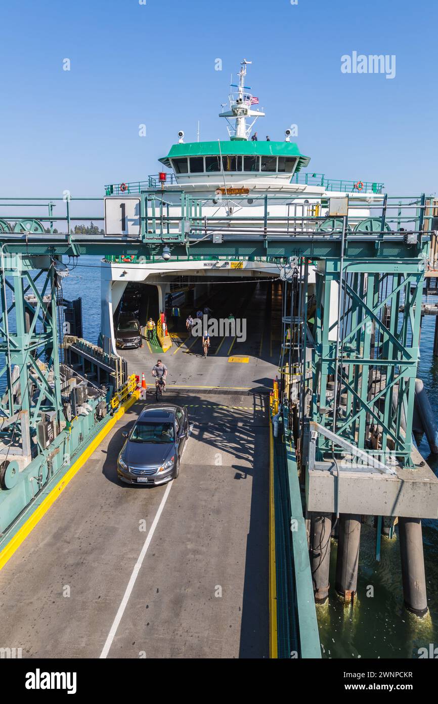 Passengers in cars and on bicycles exit the M/V Tacoma ferry boat at ...