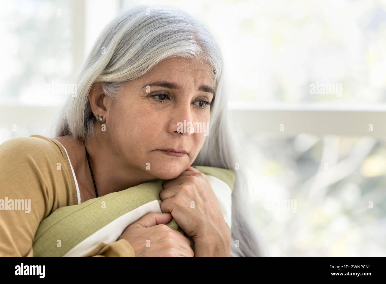 Frustrated desperate elderly Hispanic lady upset about loss, grief ...
