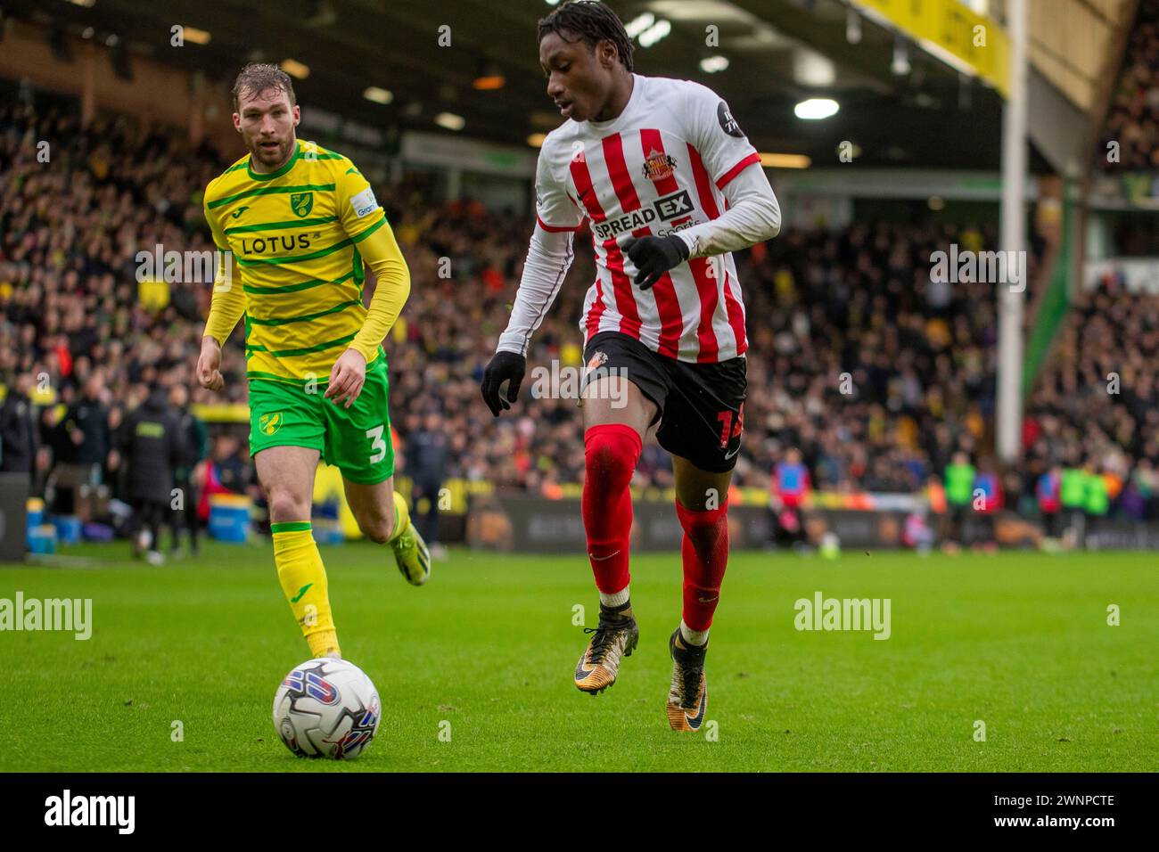 Romaine Mundle of Sunderland is put under pressure from Jack Stacey of ...