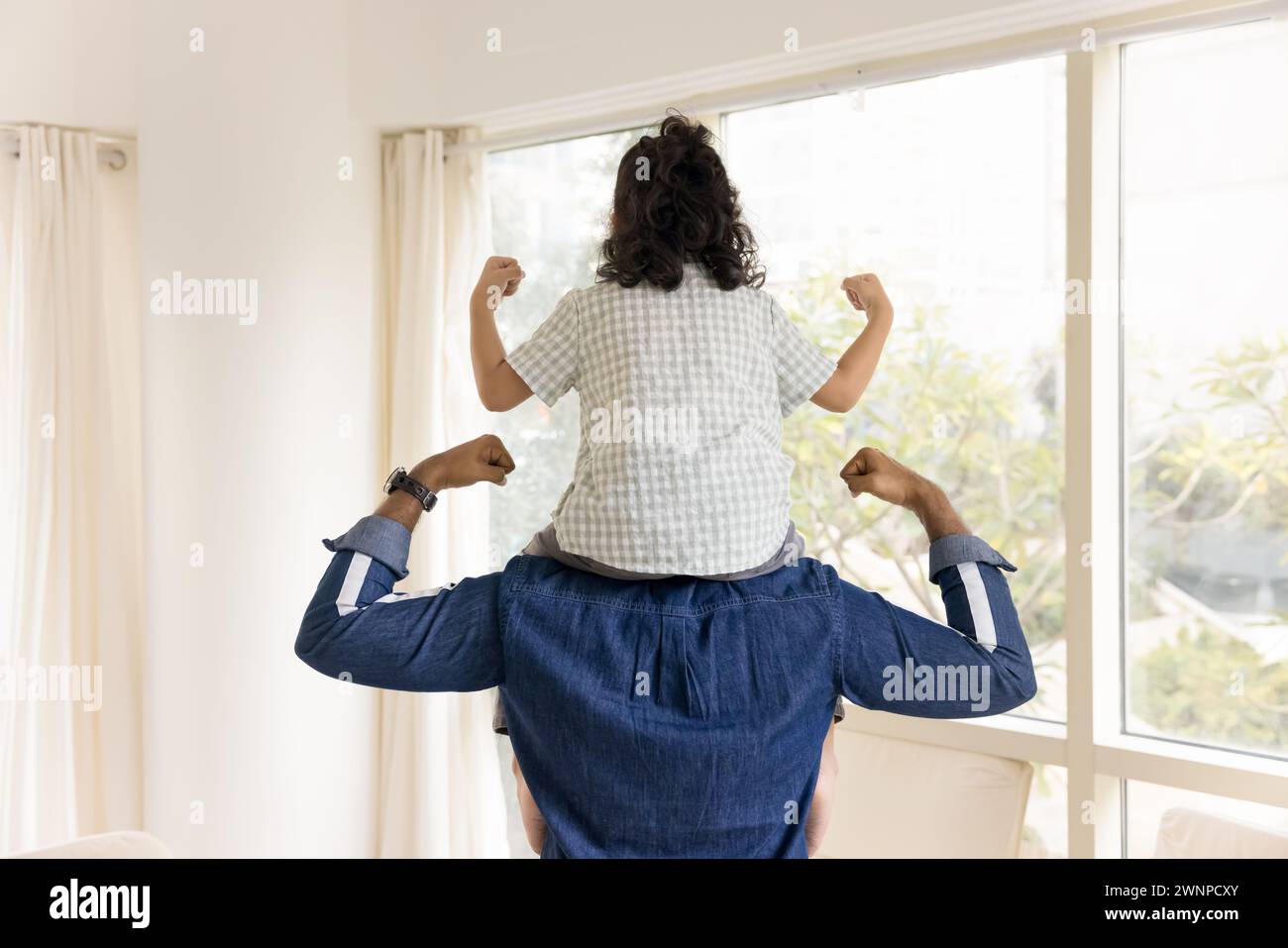Back of strong daddy and kid sitting on fathers shoulders Stock Photo ...