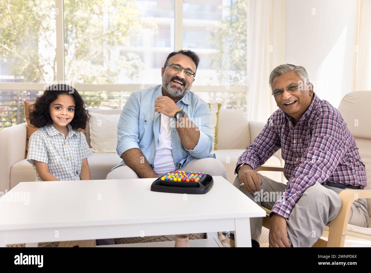 Happy Indian granddaughter, grandpa and great granddad posing for ...