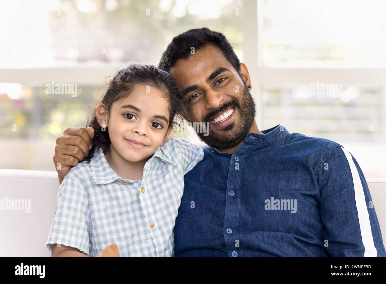 Cheerful handsome Indian dad and daughter kid looking at camera Stock ...