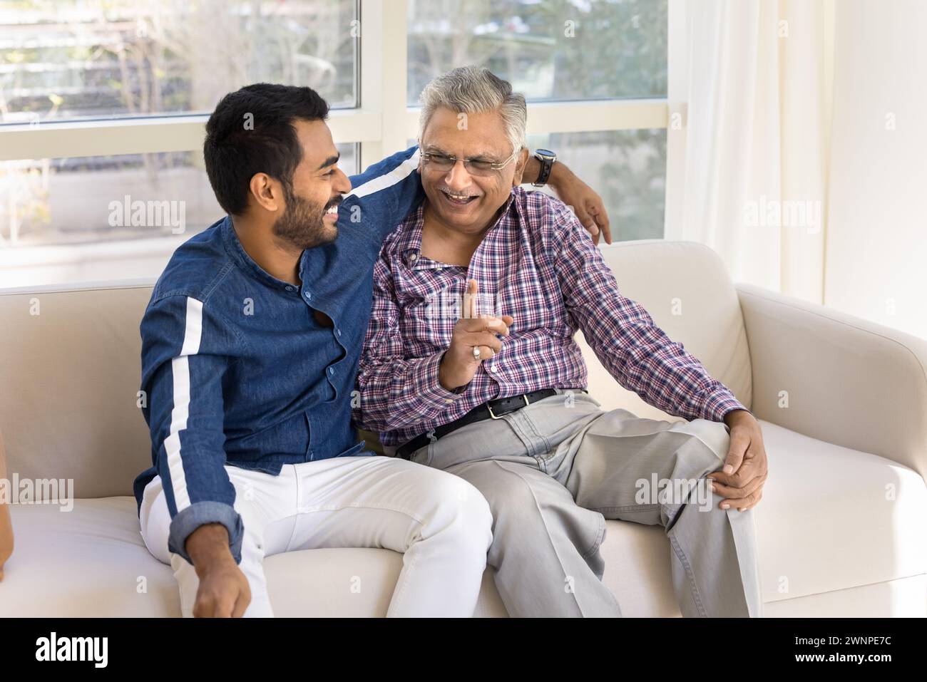 Happy older Indian father and adult son talking on sofa Stock Photo - Alamy