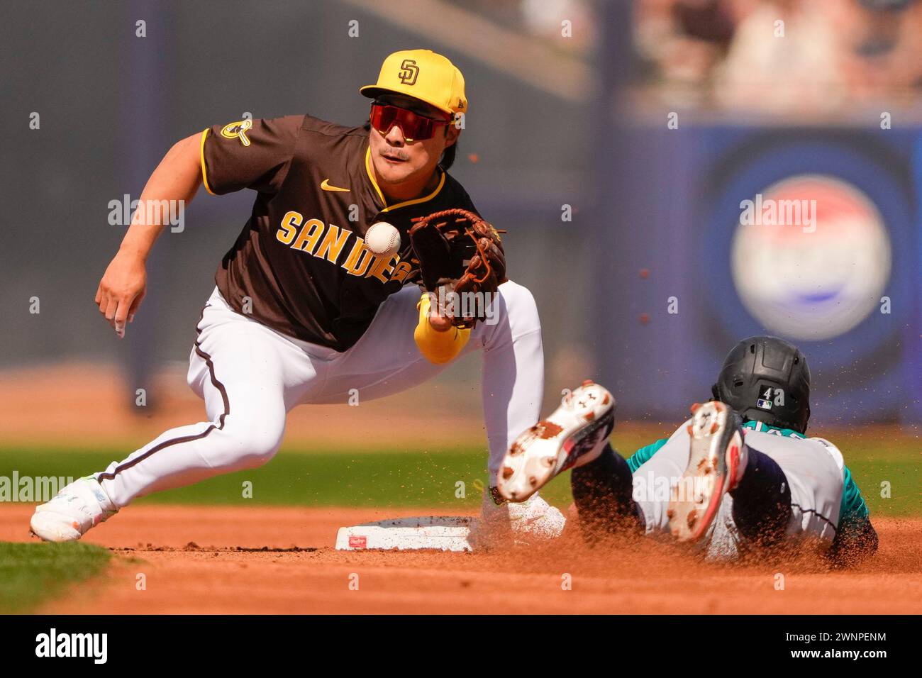 San Diego Padres shortstop Ha-Seong Kim reaches out for the ball but ...