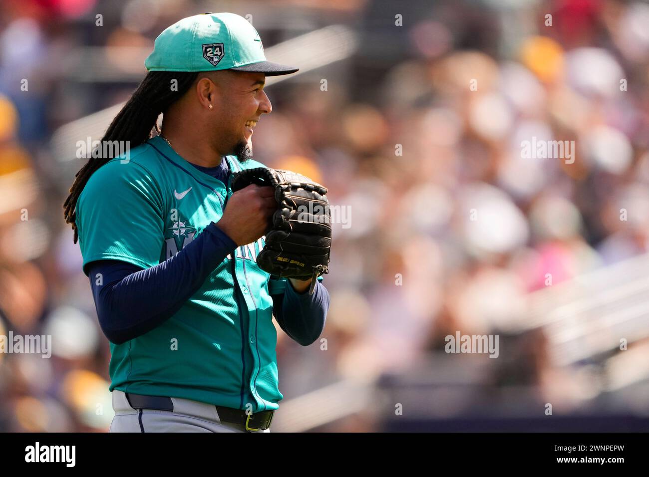 Seattle Mariners starting pitcher Luis Castillo smiles while walking ...