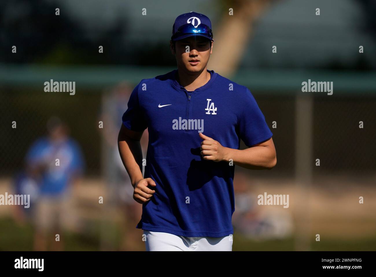Los Angeles Dodgers' Shohei Ohtani jogs across a practice field at ...