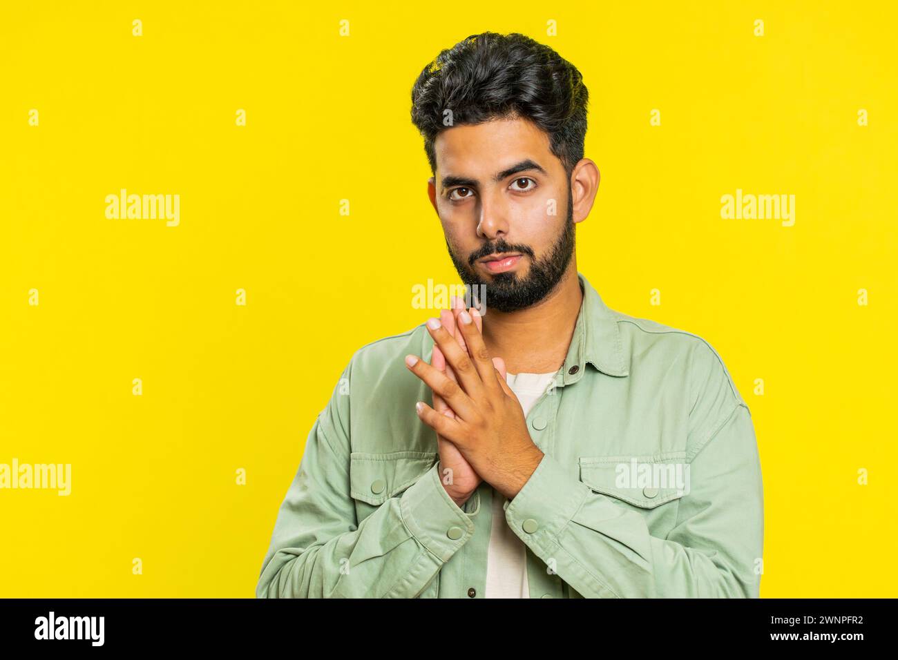 Sneaky cunning Indian young man with tricky face gesticulating and ...