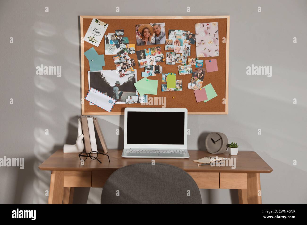 Stylish workplace with vision board and laptop Stock Photo - Alamy