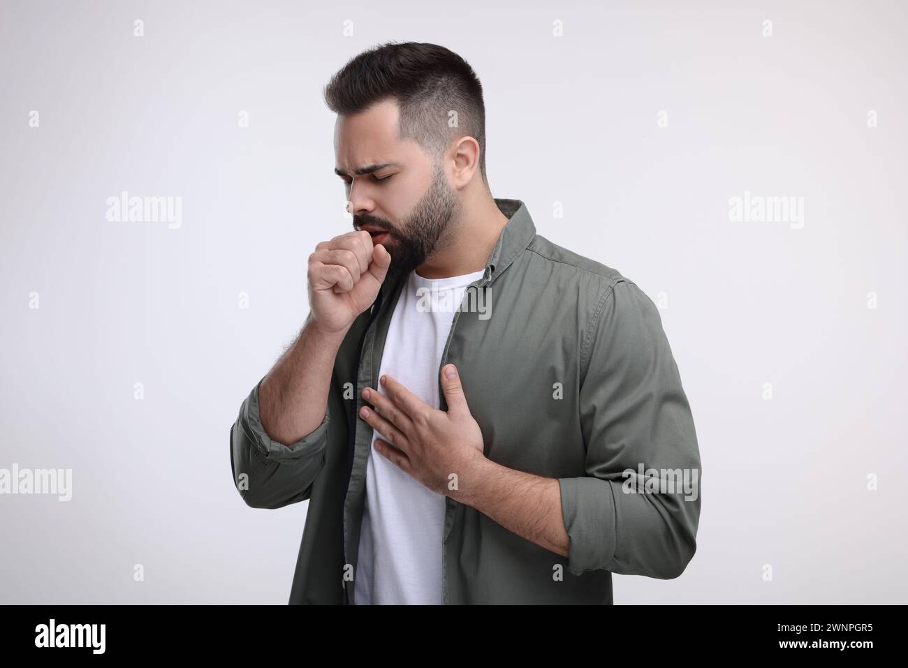 Sick man coughing on white background. Cold symptoms Stock Photo - Alamy
