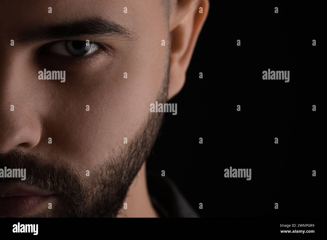 Evil eye. Man with scary eyes on black background, space for text Stock ...