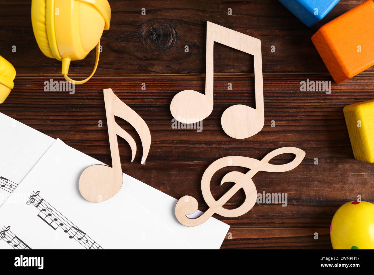 Baby song concept. Wooden notes, music sheet and toys on table, flat ...