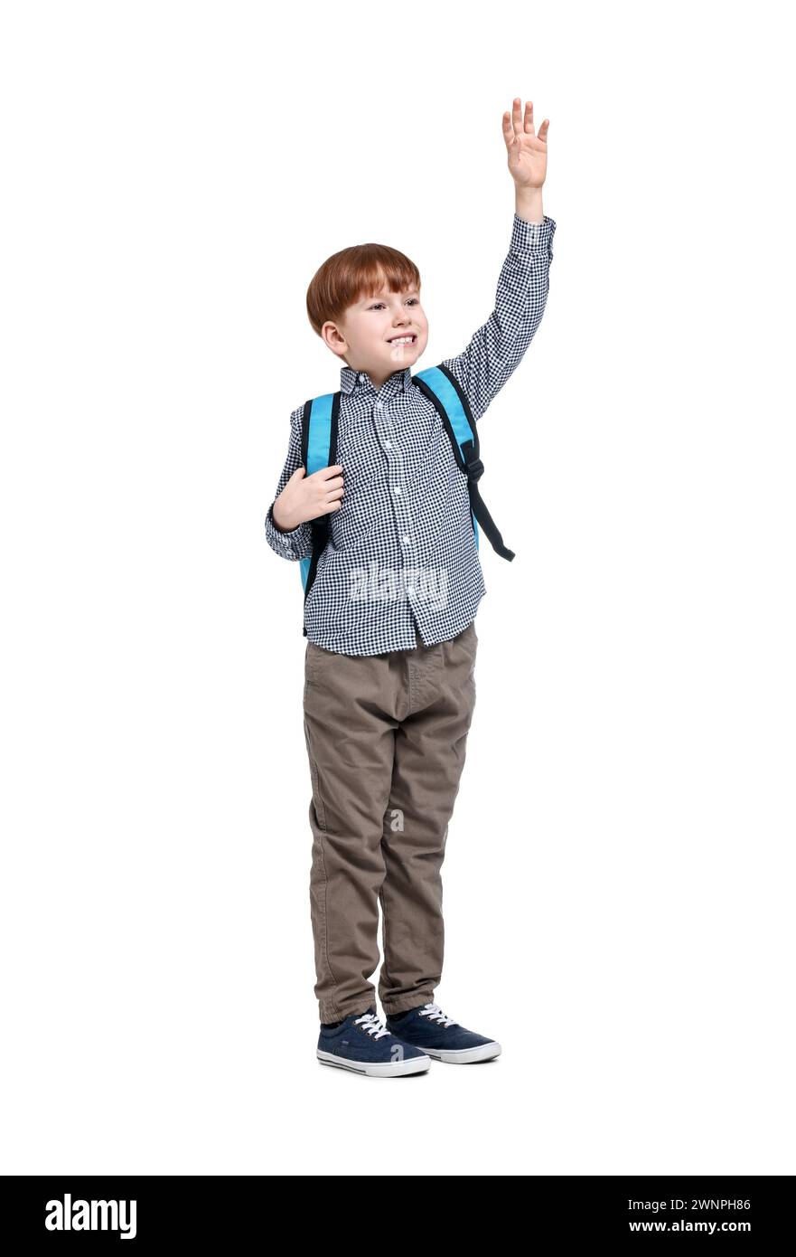 Smiling little boy with backpack waving hand on white background Stock ...