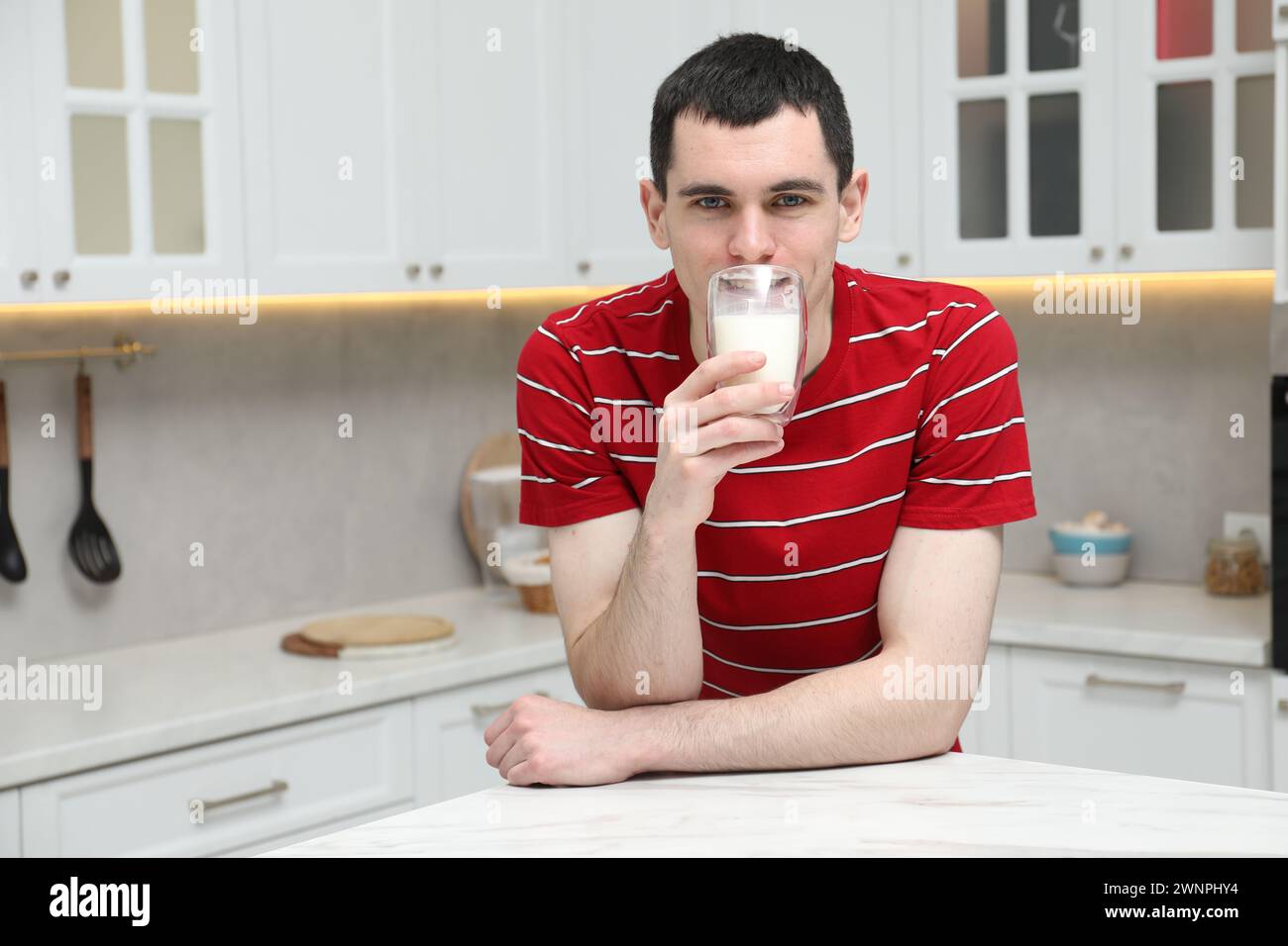 Milk mustache left after dairy product. Man drinking milk in kitchen Stock Photo - Alamy