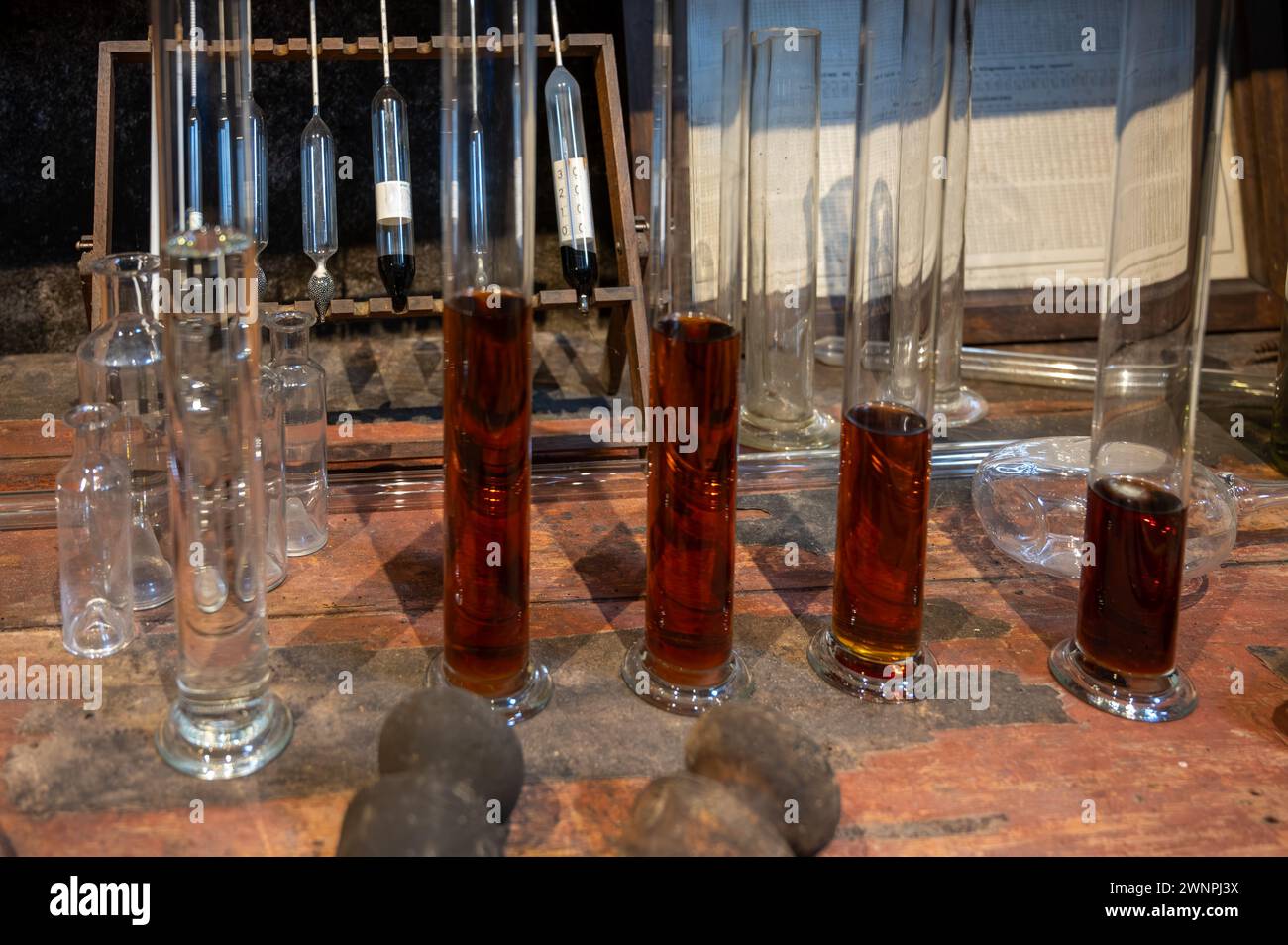 Blending process of cognac spirit and old dark French oak barrels in ...